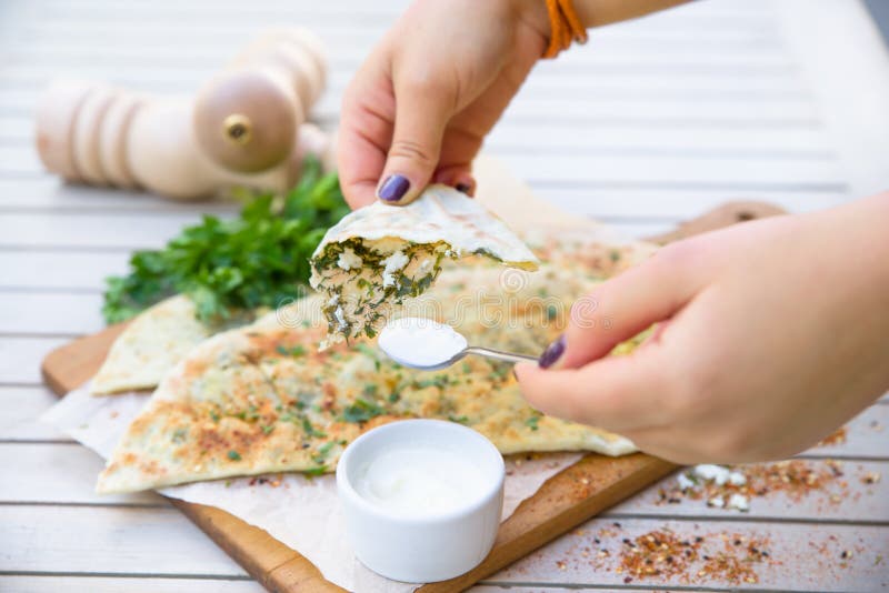 Woman Eating Turkish Gozleme Cake in Cafe, Hands in Frame Stock Photo ...