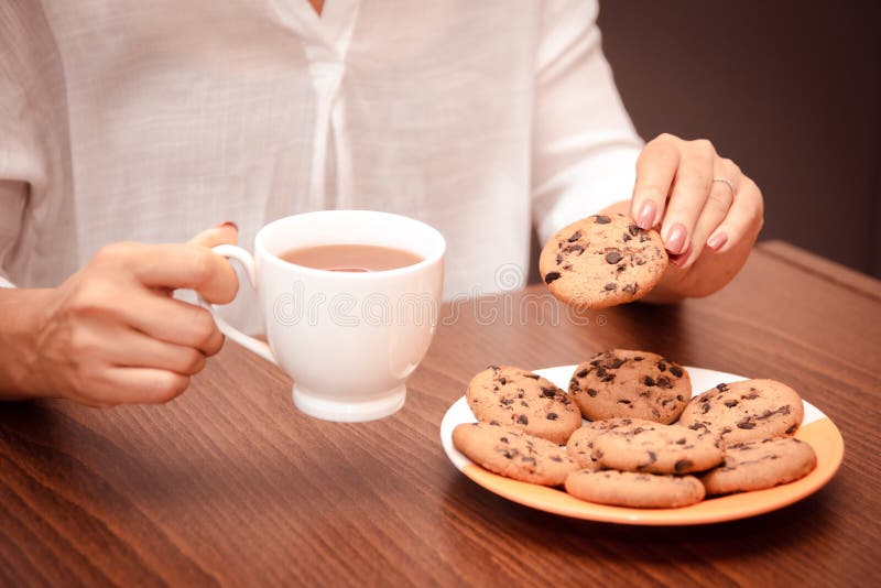 Woman Eats Cookie with Chocolate Chip and Tea in Break of Work in Home ...