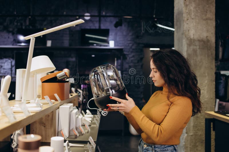 A Woman in an Electronics Store Chooses a Air Dryer. Stock Image ...