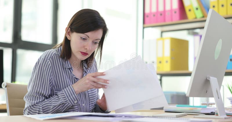 Woman Employee Works with Papers at Work Typing on Computer Stock ...