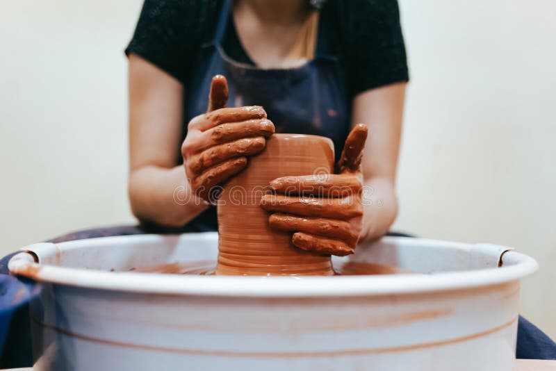 Woman is Engaged of Pottery. Potter Behind the Potter`s Wheel Forms ...