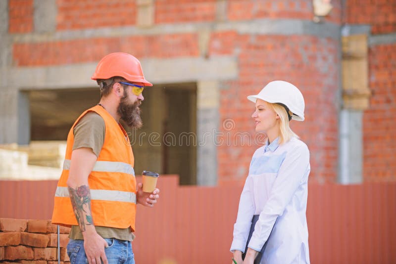 Woman Engineer and Brutal Builder Communicate Construction Site ...