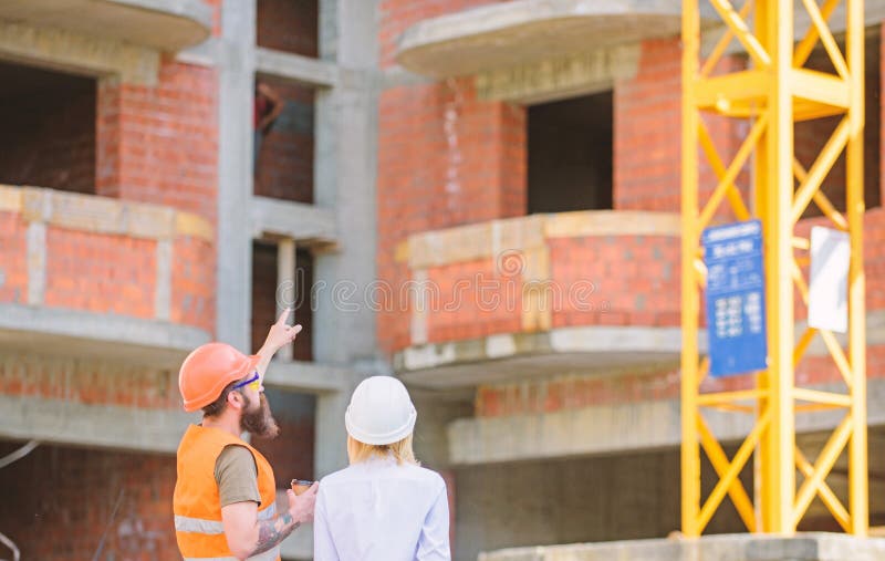 Woman Engineer and Builder Communicate at Construction Site ...