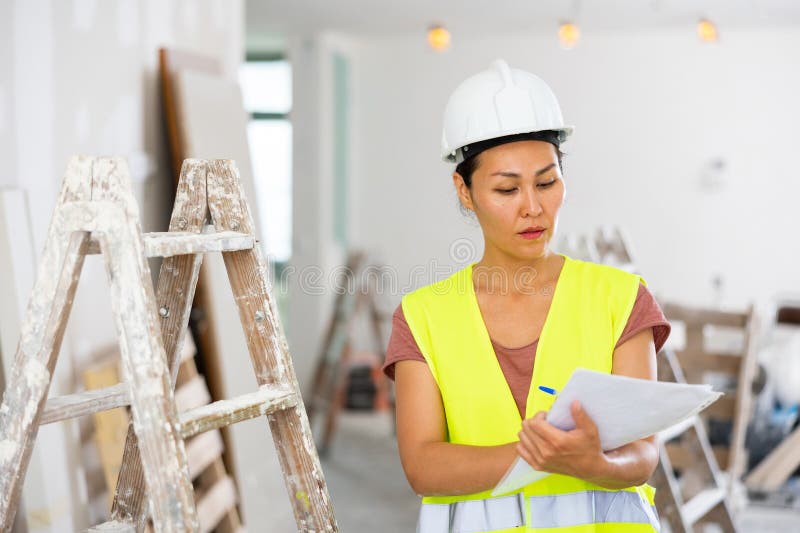 Woman Engineer Checking Documents during Repair Works Stock Image ...