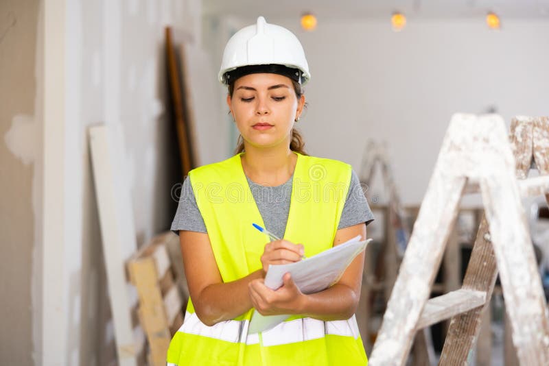 Woman Engineer Checking Documents during Repair Works Stock Image ...