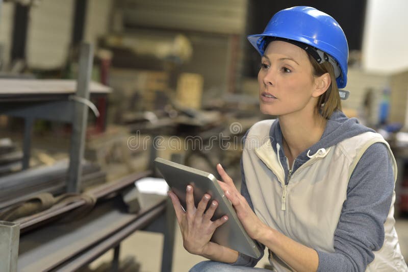Woman Engineer with a Security Helmet in Steel Plant Using Tablet Stock ...