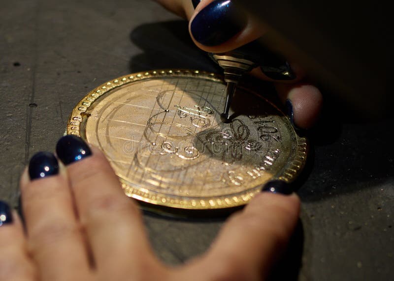 Woman engraver at work. stock photo. Image of instruments - 150816860