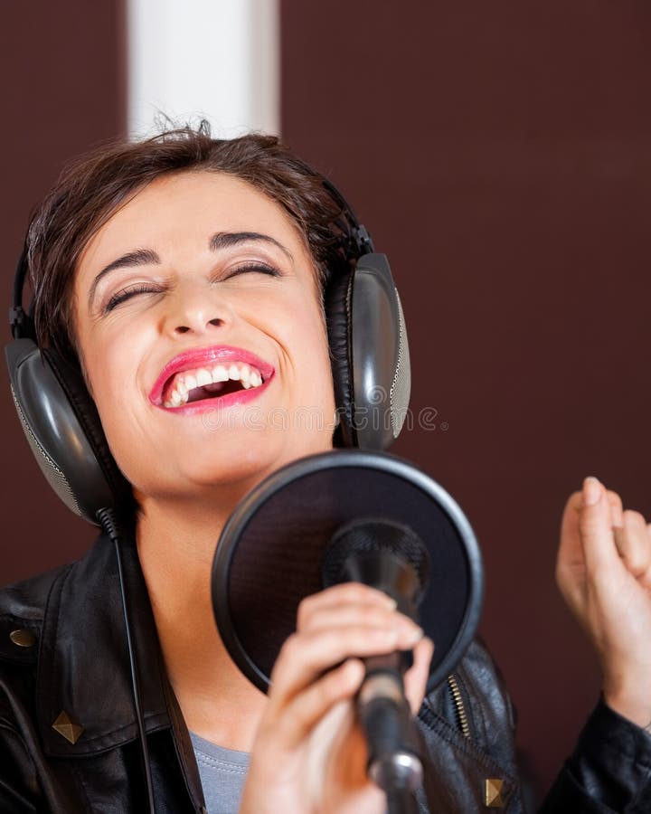 Woman Enjoying while Singing in Studio Stock Photo - Image of eyes ...
