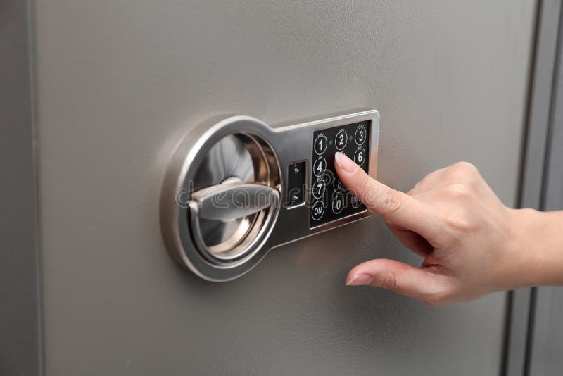 Woman Entering Code on Keypad of Safe, Closeup Stock Photo - Image of ...
