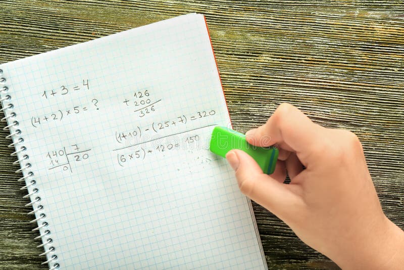 Woman Erasing Mistake in Notebook with Math Equation, Top View Stock ...