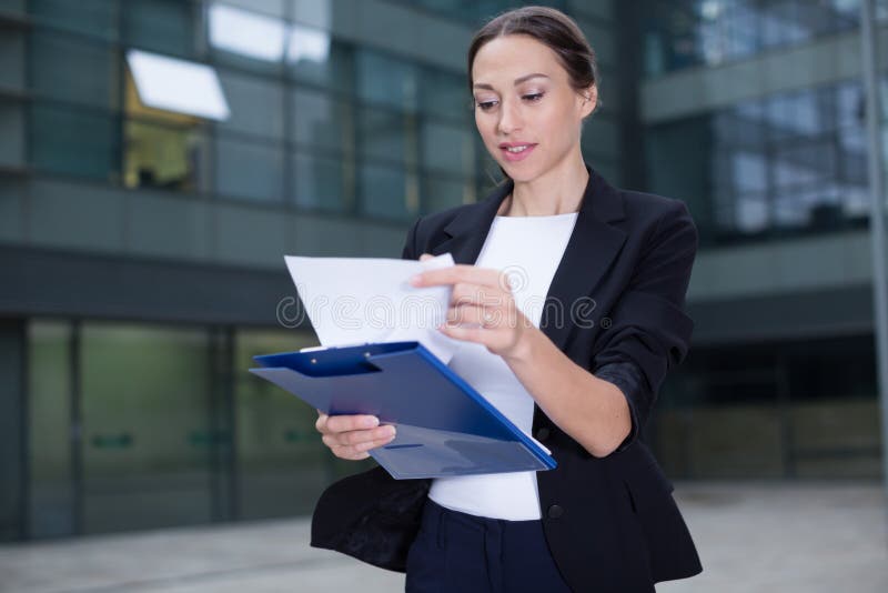 Woman is Examining Documents Stock Photo - Image of documents, papers ...