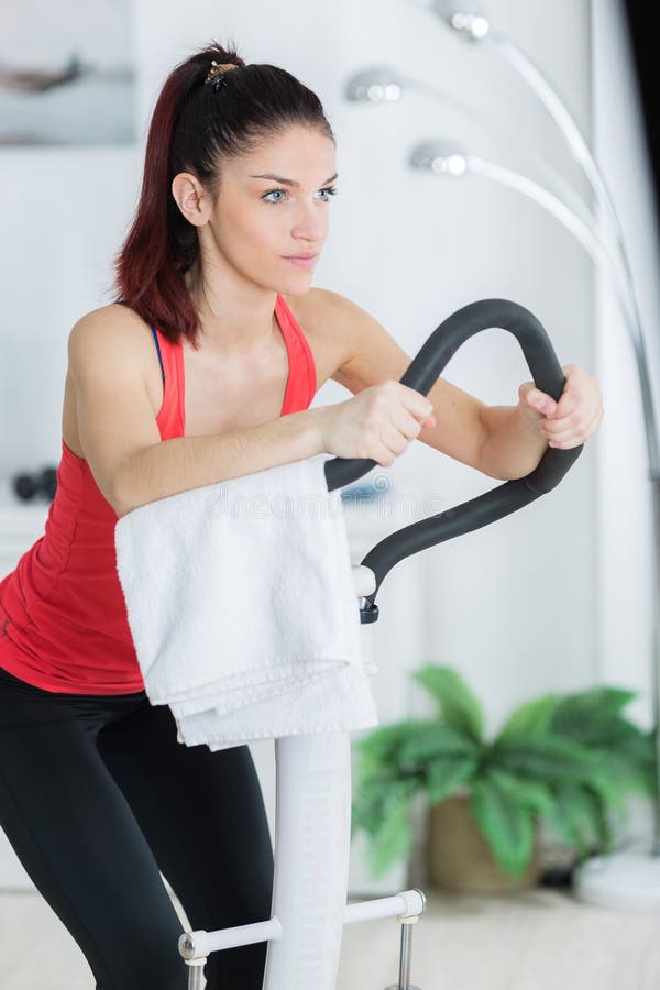 Woman on exercise machine stock image. Image of activity - 202175641