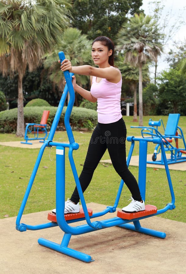 Woman Exercising with Exercise Equipment in the Park Stock Photo ...