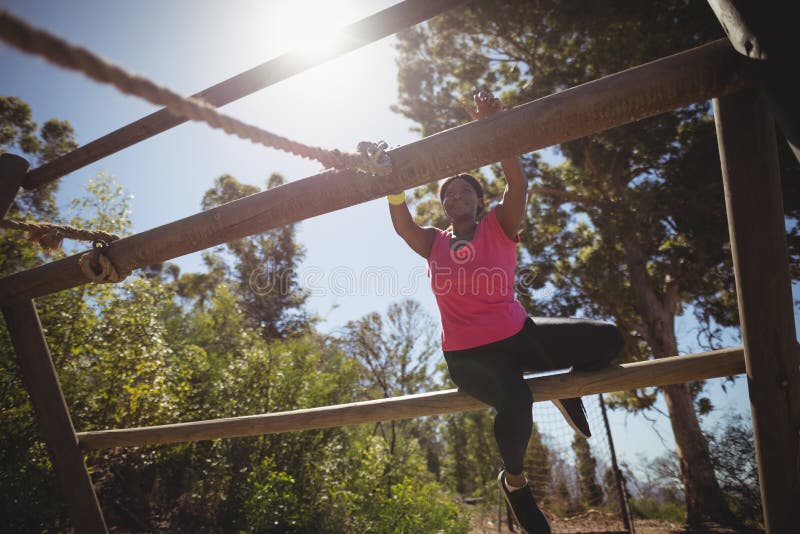 Woman Exercising on Outdoor Equipment during Obstacle Course Stock ...