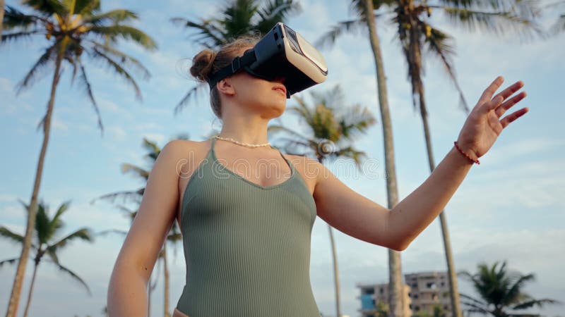 Woman Experiences VR Headset among Palm Trees, Explores Virtual Space ...