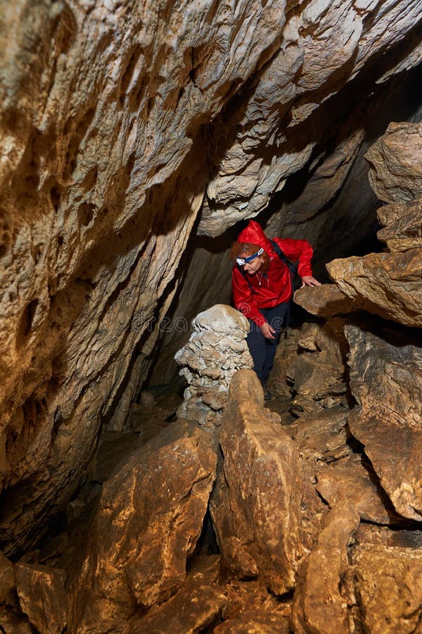 Woman explorer in a cave stock image. Image of explorer - 252875351