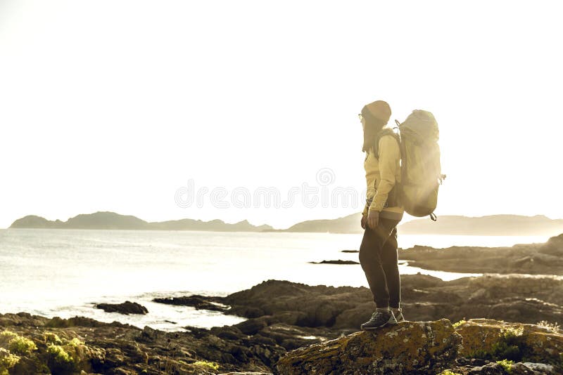 Woman Exploring the Coastline with Backpack Stock Image - Image of ...