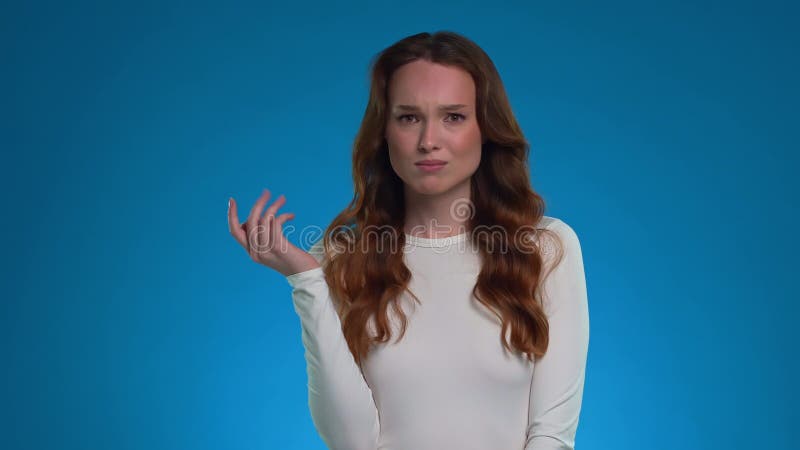 Woman Expressing Deep Emotions in Beauty Studio with Vibrant Blue ...