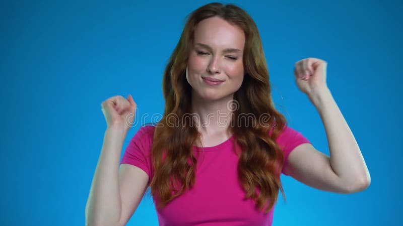 Woman Expressing Joy and Positivity while Posing in Studio Setting ...