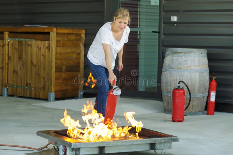 Woman Extinguishing Fire Drill Stock Photo - Image of firefighter, safe ...