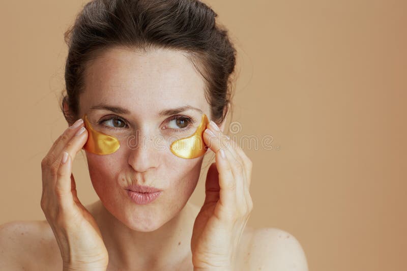 Woman with Eye Patches Isolated on Beige Background Stock Image - Image ...