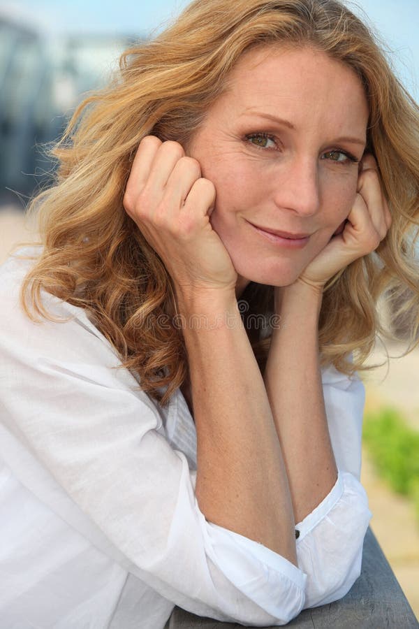 Woman with Face Resting on Hands Stock Photo - Image of casual, green ...