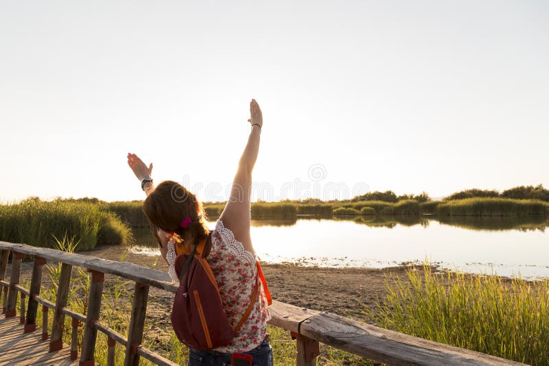 Woman facing the sunset stock photo. Image of park, woman - 76538410