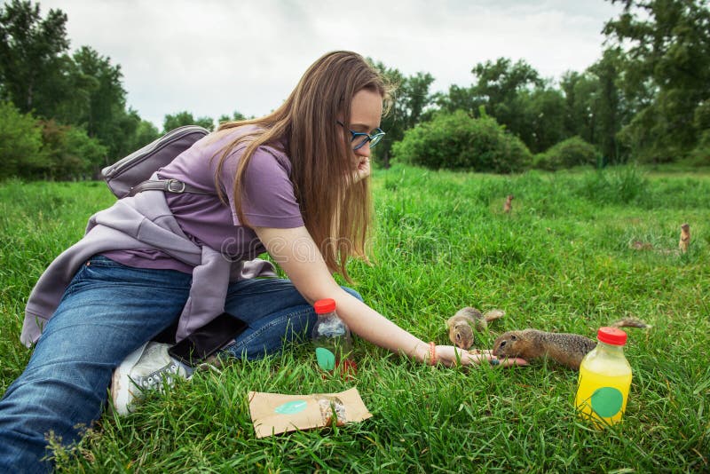 Woman feeding gopher stock image. Image of herbivore - 231306021