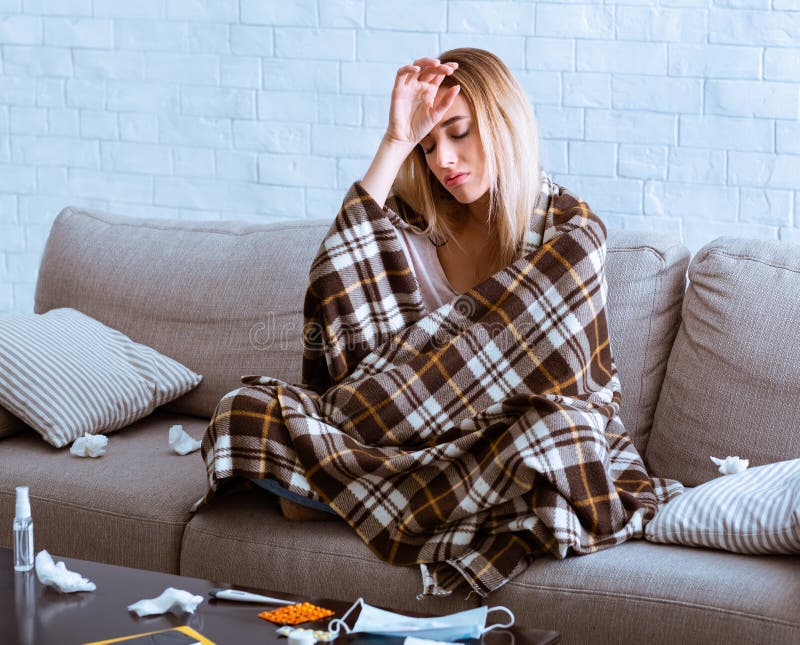 Woman Feeling Cold, Covered Blanket and Touches Forehead Stock Image ...
