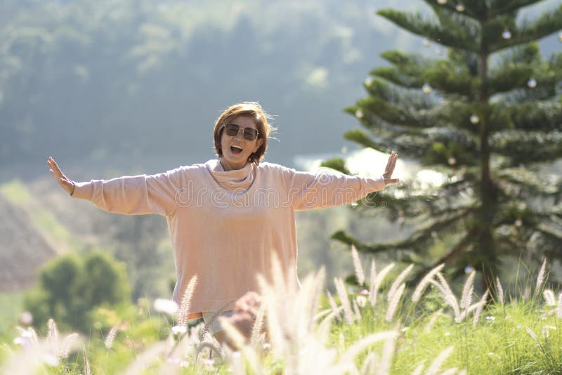 Woman Feeling Freedom Standing in Natural Grass Field Stock Photo ...