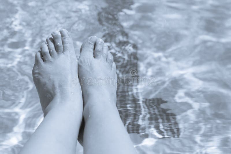 Woman feet on pool water stock image. Image of relax - 80025219
