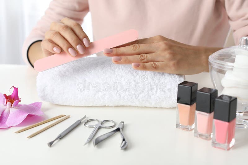 Woman Filing Nails Covered with Polish at Table Stock Photo - Image of ...