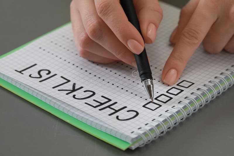 Woman Filling Checklist with Pen at Grey Table, Closeup Stock Image ...