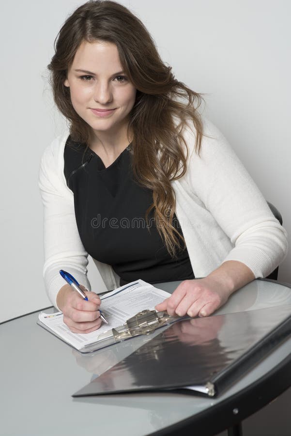Woman filling out form stock image. Image of busy, paper - 52007359