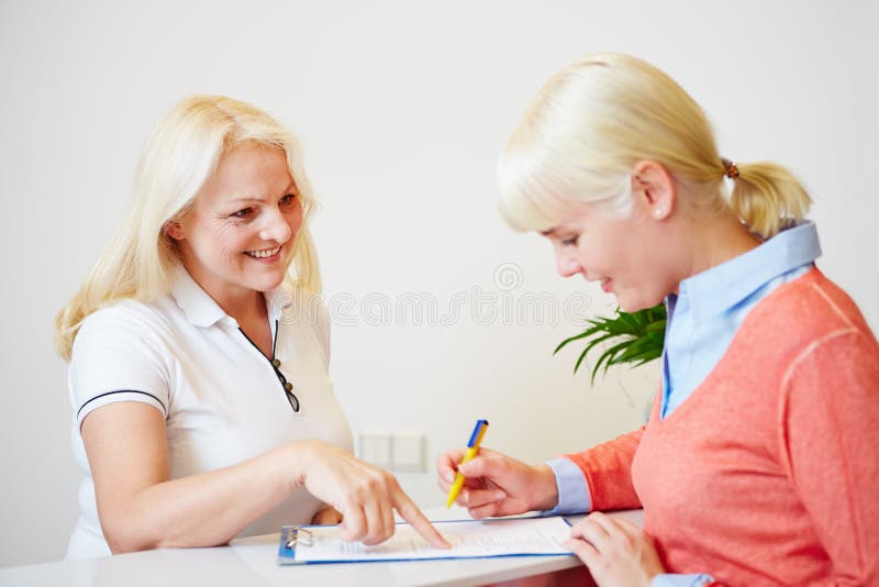 Woman Filling Out Patient Forms at Dentist Stock Image - Image of date ...
