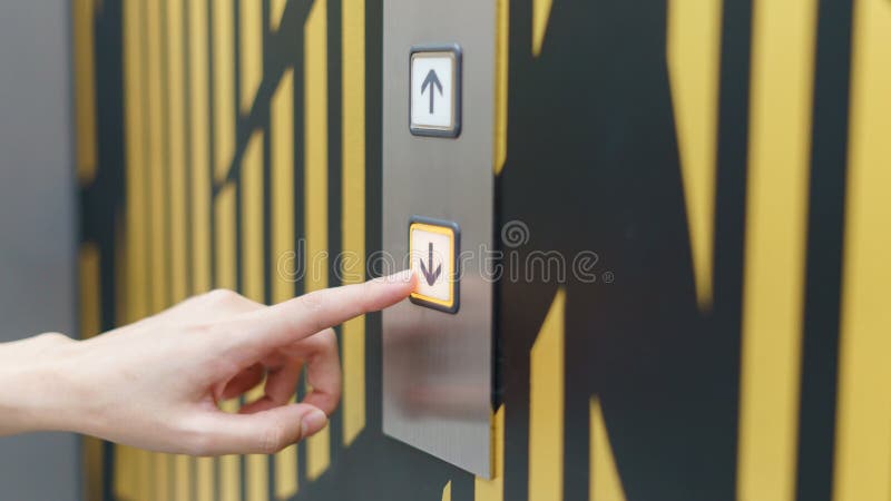 Woman Finger Pressing a Down Button of Elevator Button Inside the ...