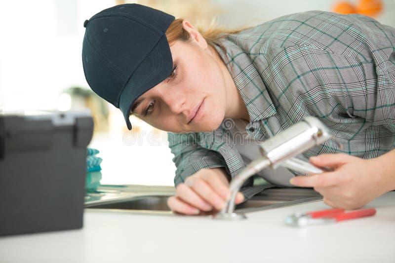 Woman fixing kitchen sink stock image. Image of english - 270025545