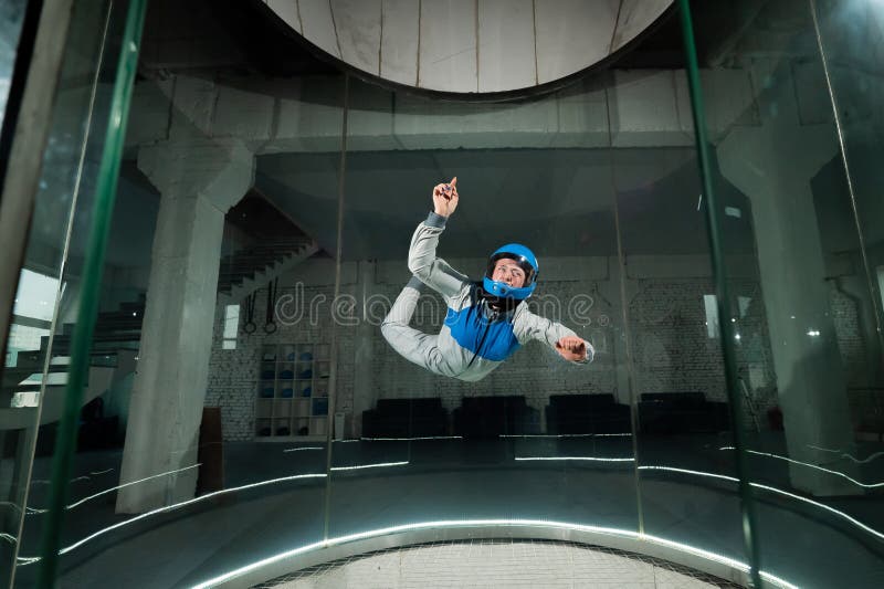 A Woman Flies in a Wind Tunnel. Free Fall Simulator. Stock Photo ...