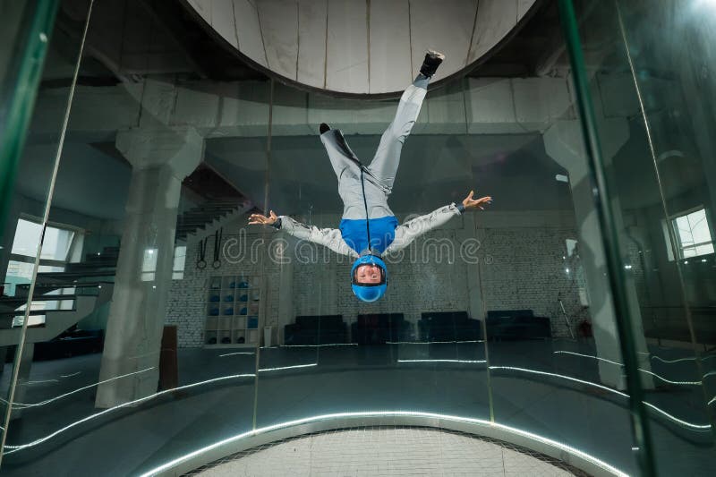 A Woman Flies in a Wind Tunnel. Free Fall Simulator. Stock Photo ...