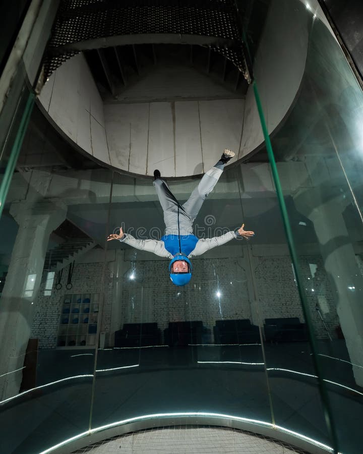 A Woman Flies in a Wind Tunnel. Free Fall Simulator. Stock Photo ...