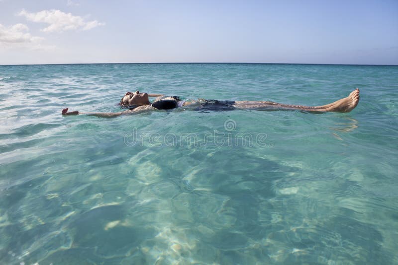 Woman floating in the sea stock image. Image of enjoy - 21669701