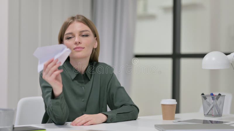 Young Woman Flying Paper Plane while Working on Laptop Stock Photo ...