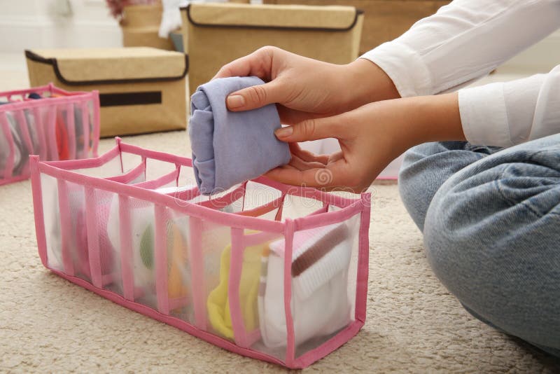 Woman Folding Clothes on Floor, Closeup. Japanese Storage System Stock ...