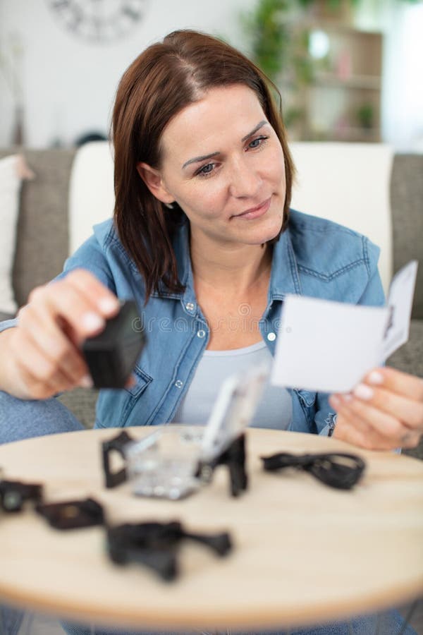 Woman Following Instructions To Assemble Action Camera Stock Photo ...