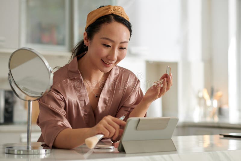 Woman Following Makeup Tutorial Stock Photo - Image of beauty, watch ...