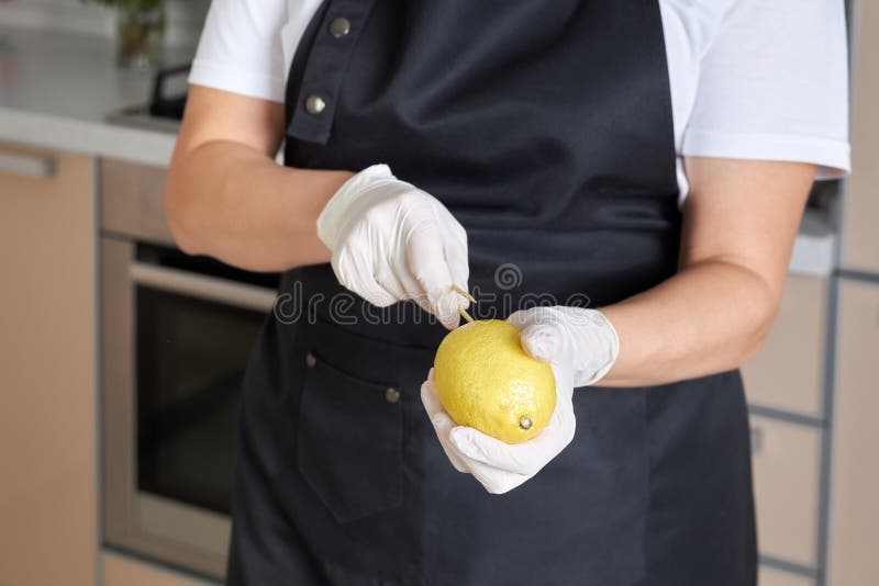 A Woman Forces on a Lemon on a Stick Making a Blank for Her Fruit ...