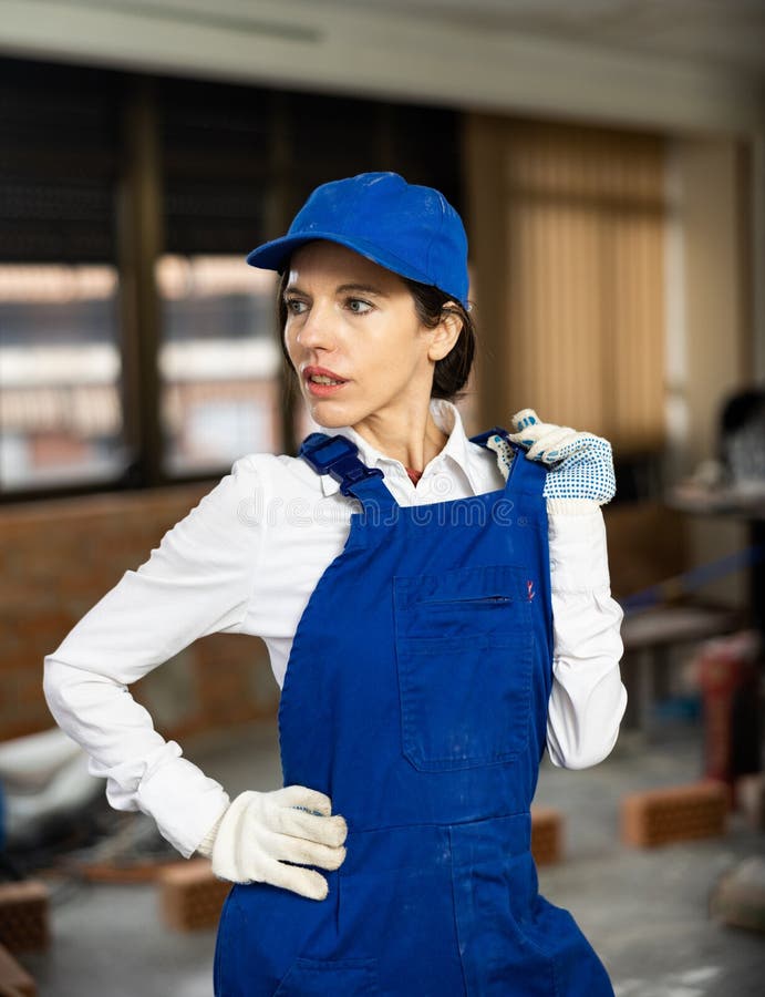 Woman Foreman in Blue Overalls Posing in House Under Construction Stock ...