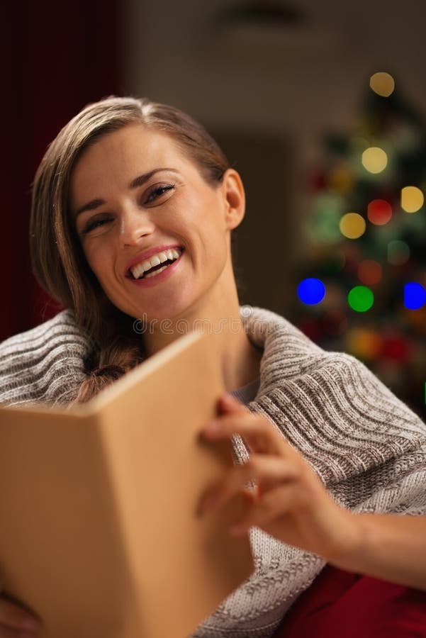 Woman in Front of Christmas Tree Reading Book Stock Photo - Image of ...