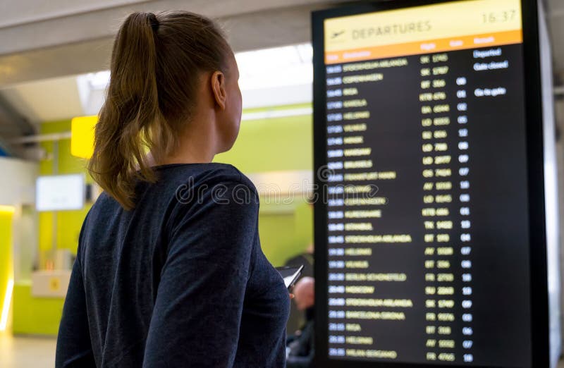 Woman checking her flight stock photo. Image of arrival - 163572748