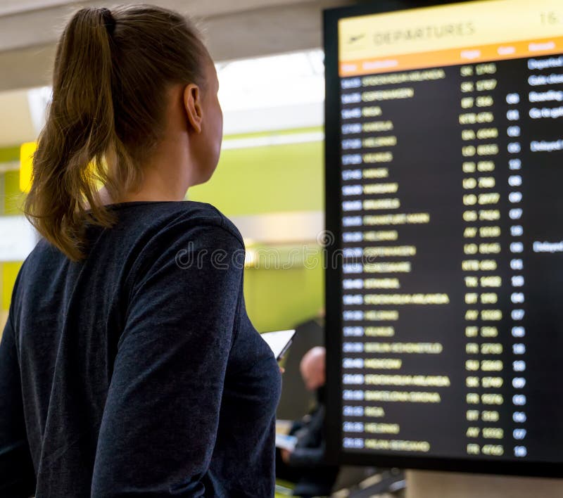 Woman checking her flight stock photo. Image of interior - 163572816